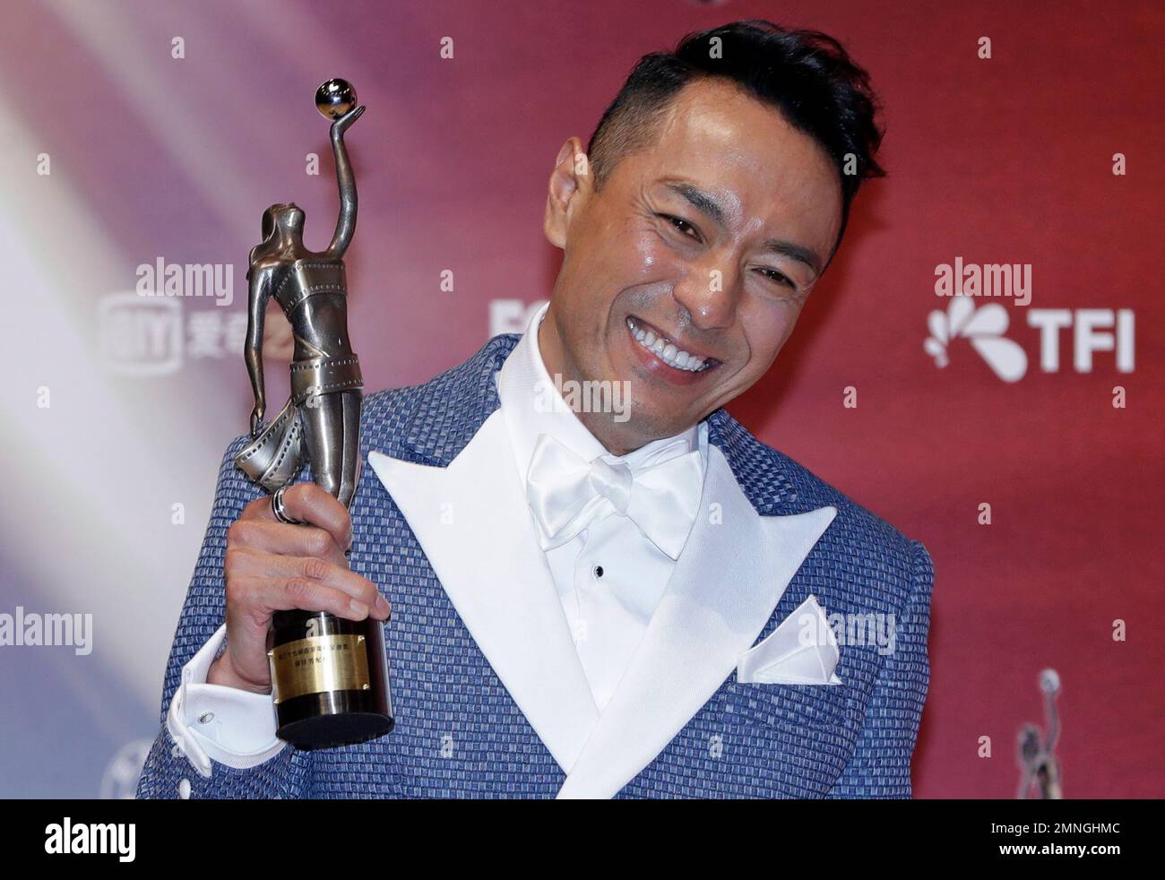 Hong Kong actor Philip Keung poses after winning the Best Supporting ...