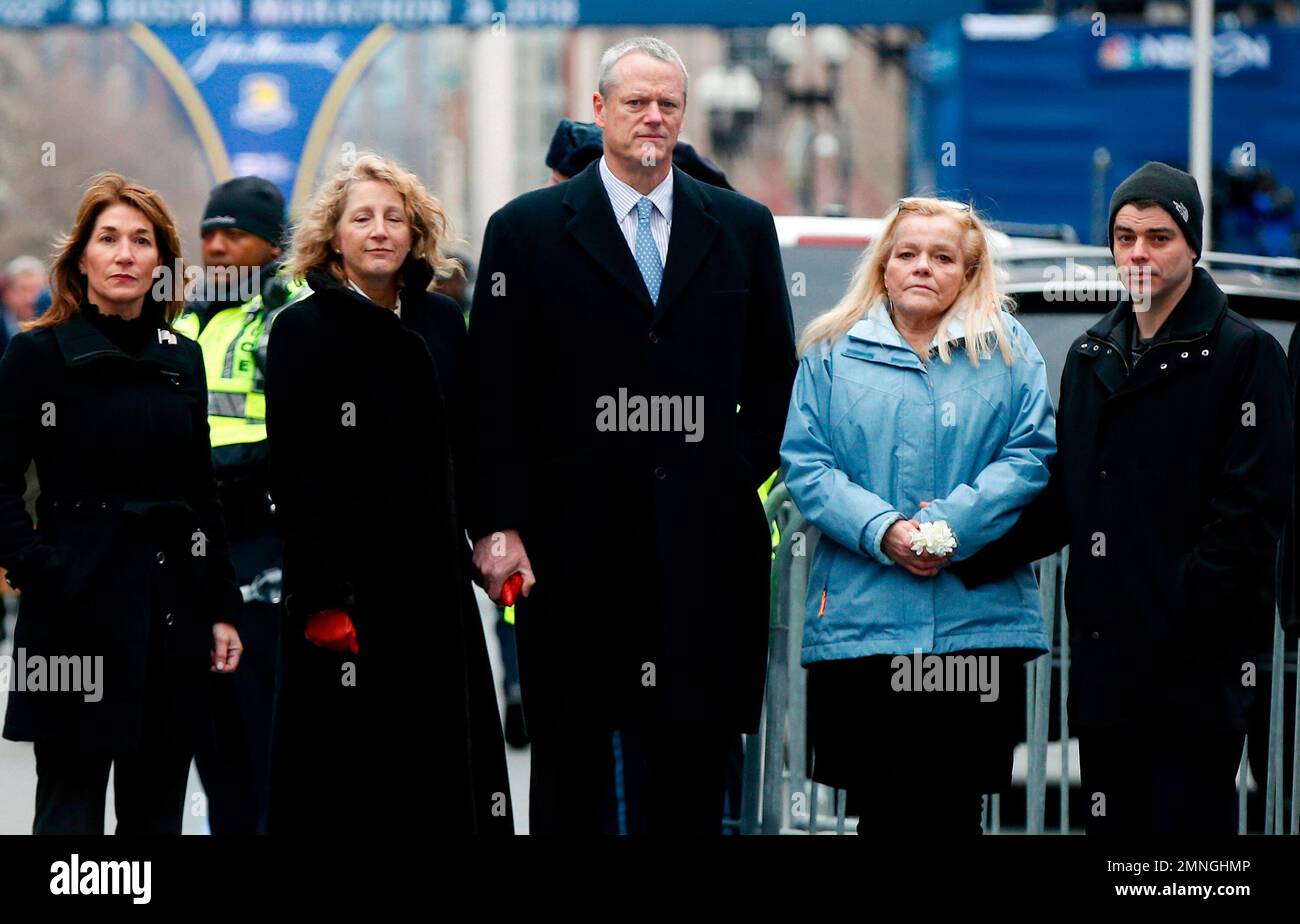 Massachusetts Gov. Charlie Baker, center, stands with the mother of ...