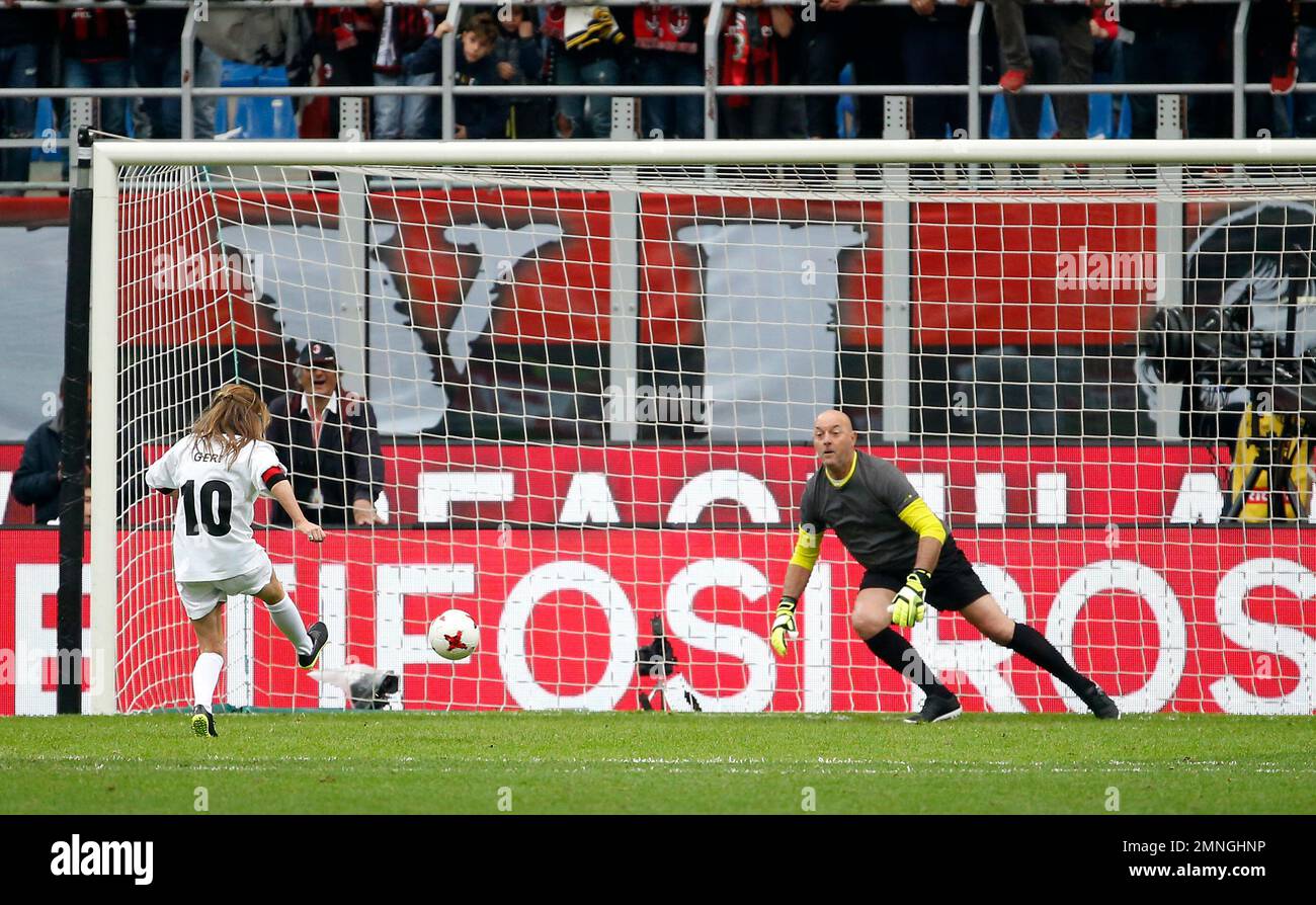Geri Halliwell, left, kicks a penalty kick against former Liverpool ...
