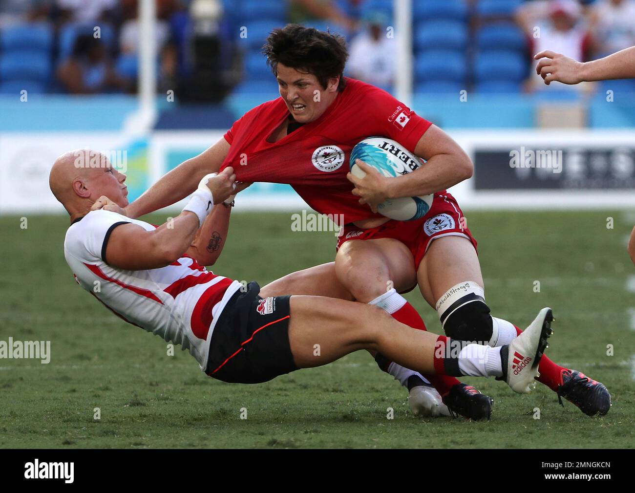 England's Heather Fisher, left, tackles Canada's Brittany Benn during ...