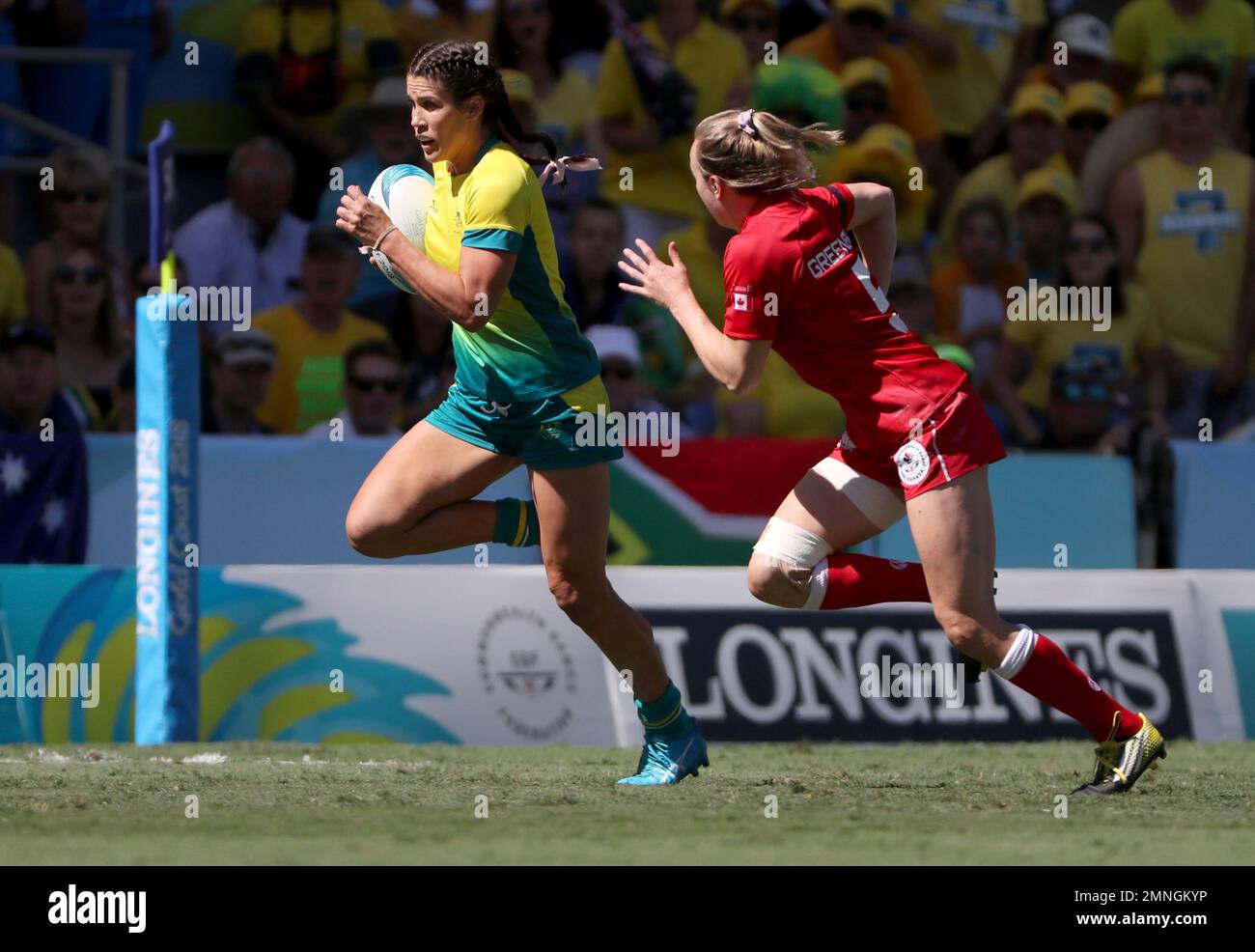 Australia's Charlotte Caslick, left, runs past Canada's Julia ...
