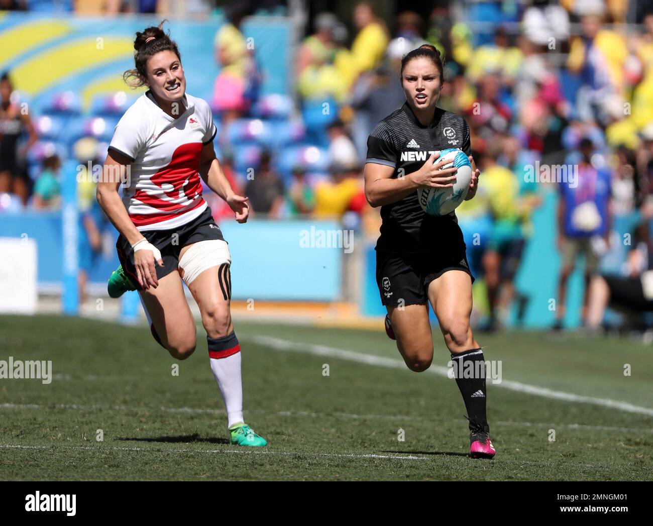 New Zealand's Michaela Blyde runs past an England defender during their ...