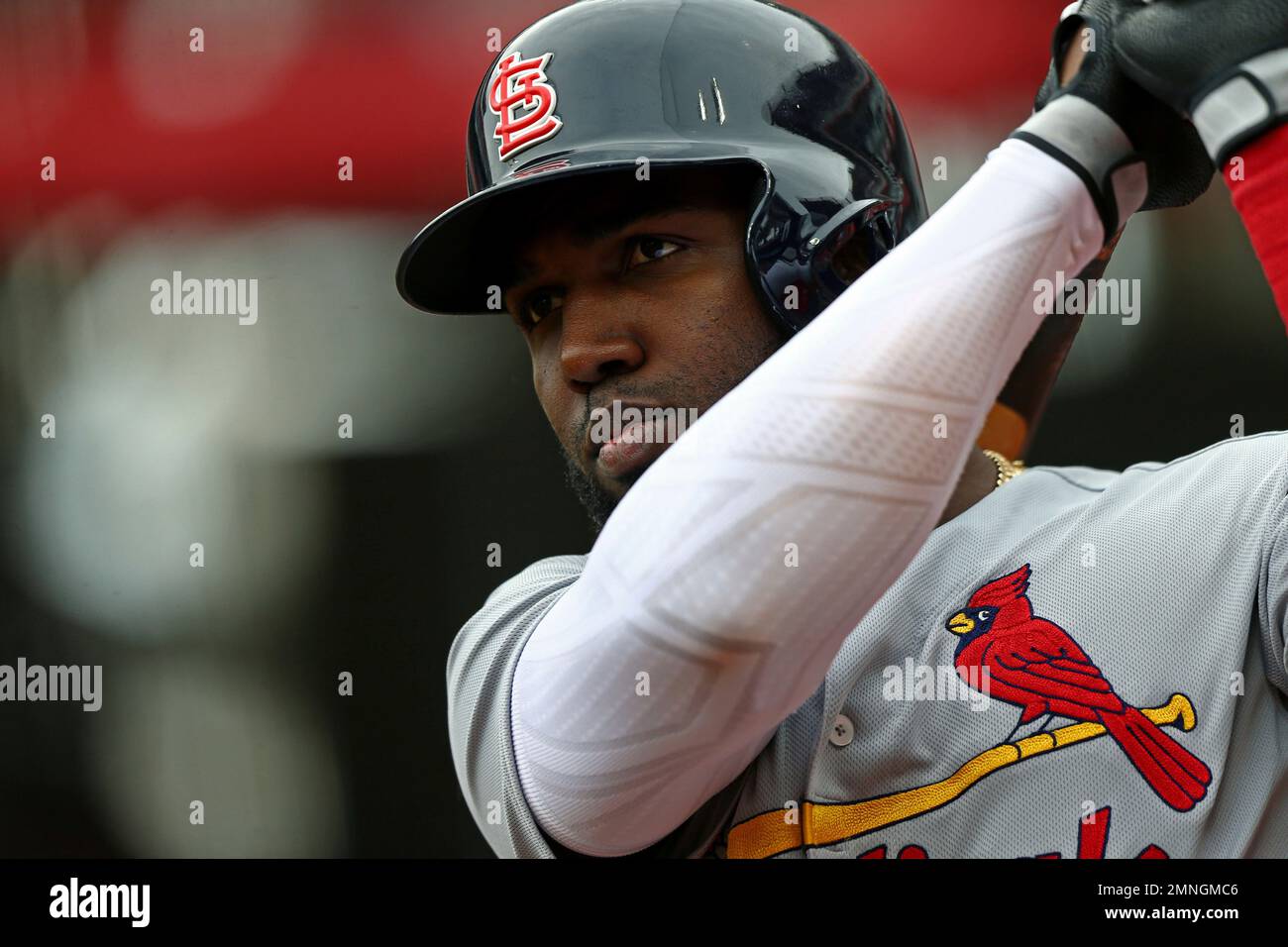 St. Louis Cardinals' Marcell Ozuna takes a practice swing as he waits ...