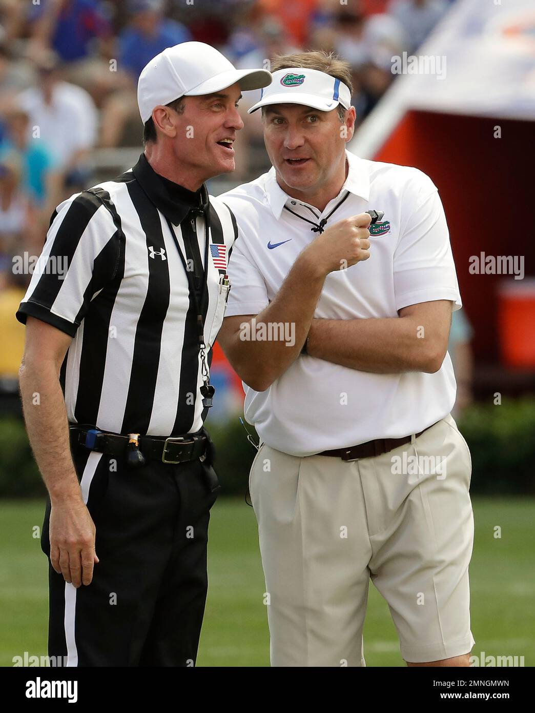 Florida head coach Dan Mullen, right, talks with an official during an ...
