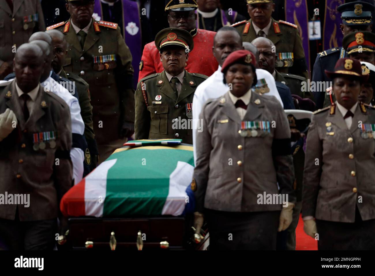 Military pallbearers carry the coffin of struggle icon Winnie ...