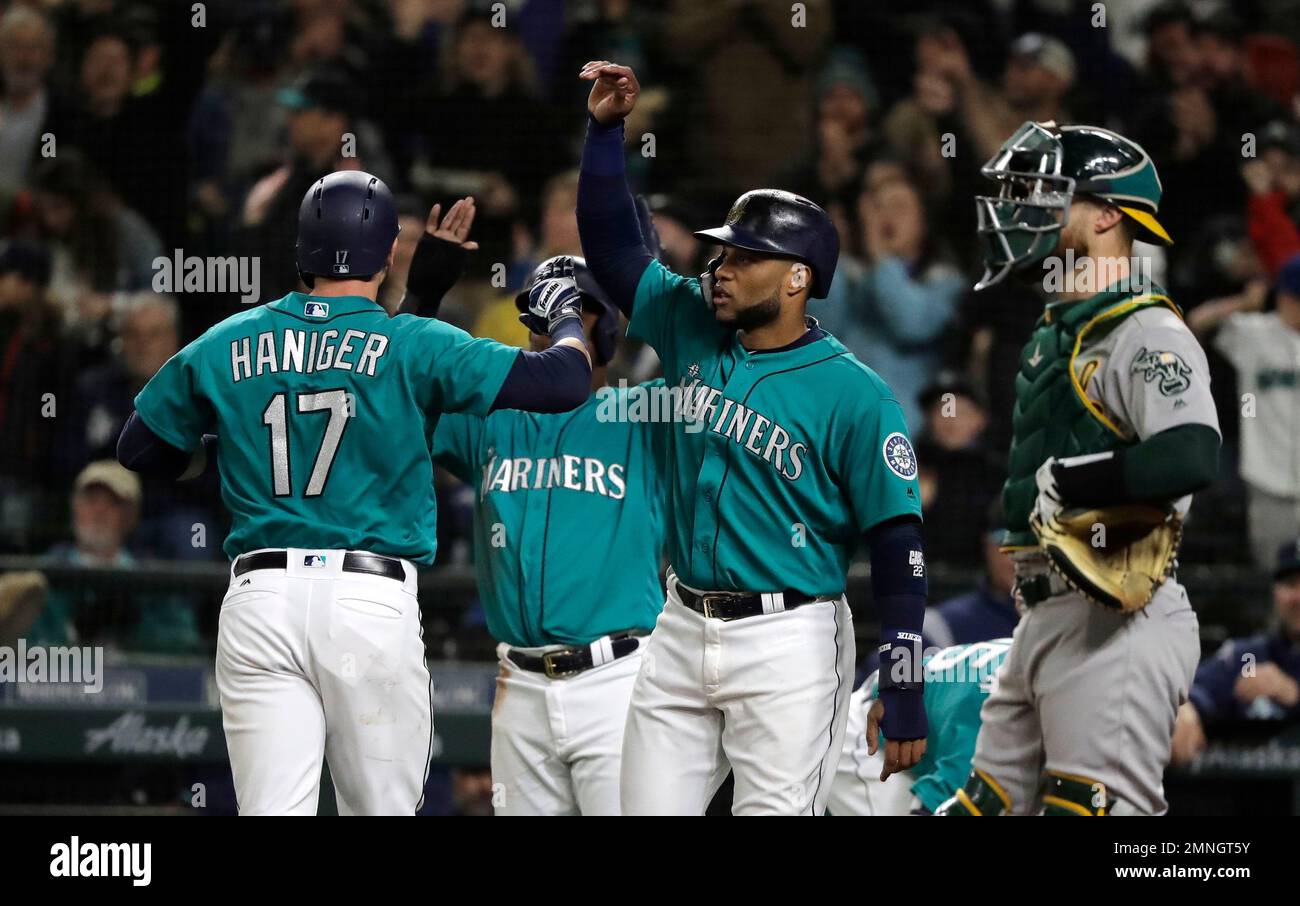 Seattle Mariners' Mitch Haniger (17) is greeted at the plate by ...