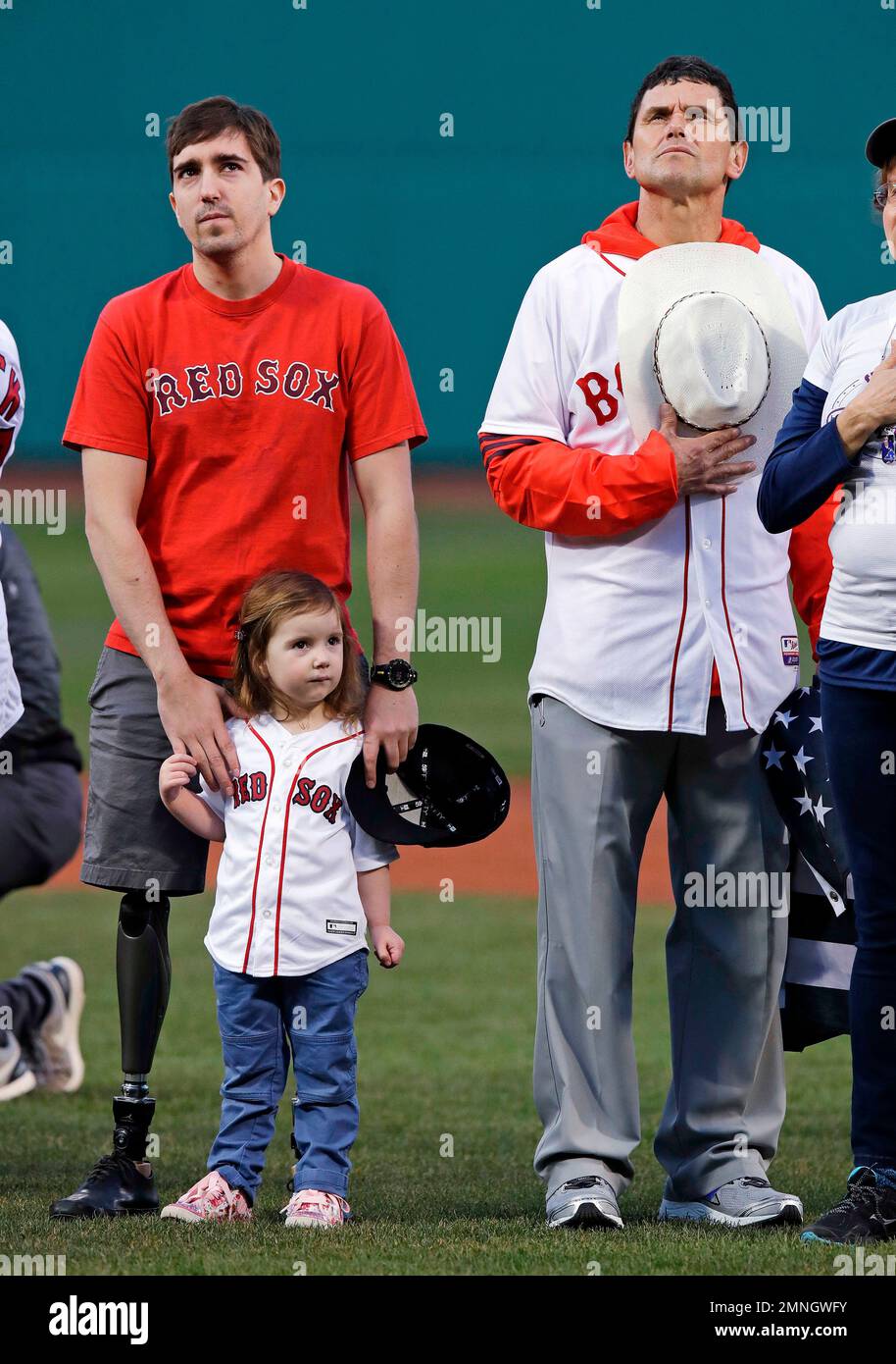 Boston Marathon bombing survivor Jeff Bauman, left, stands with his ...