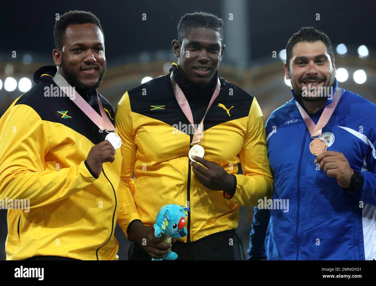 Men's discus throw gold medalist Jamaica's Fedrick Dacres, centre ...