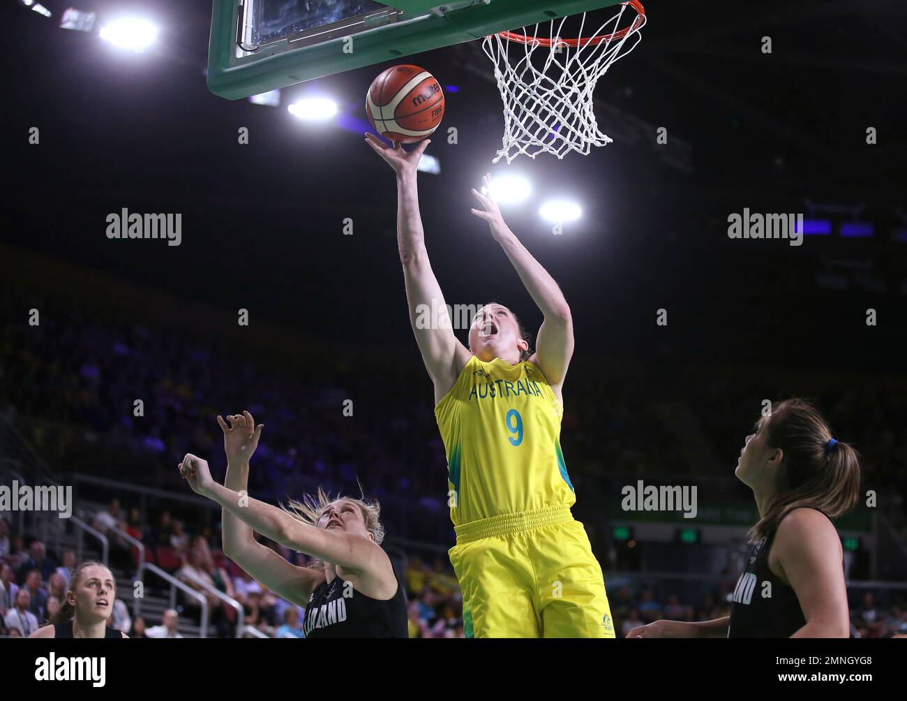 Australia's Kelsey Griffin, center, lays the ball up over New Zealand's ...