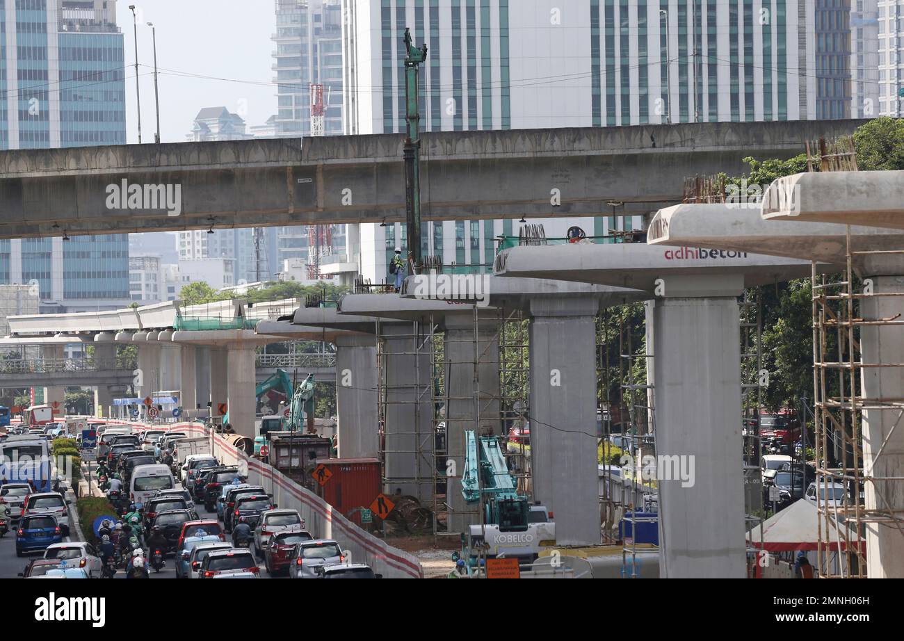 Cars line up in a traffic congestion next to Light Rapid Transit (LRT ...