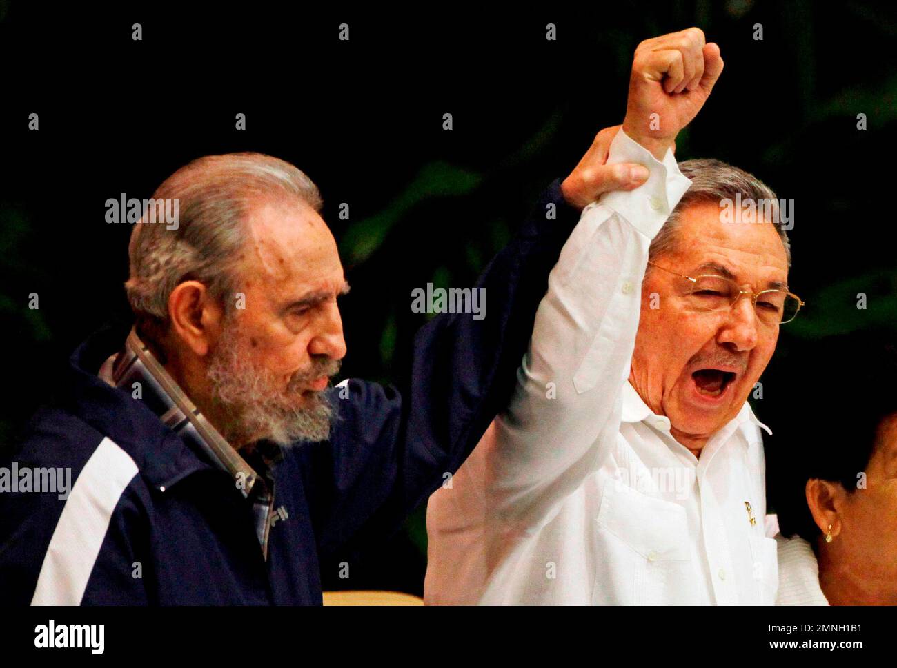 FILE - In this April 19, 2011 file photo, Fidel Castro, left, raises ...