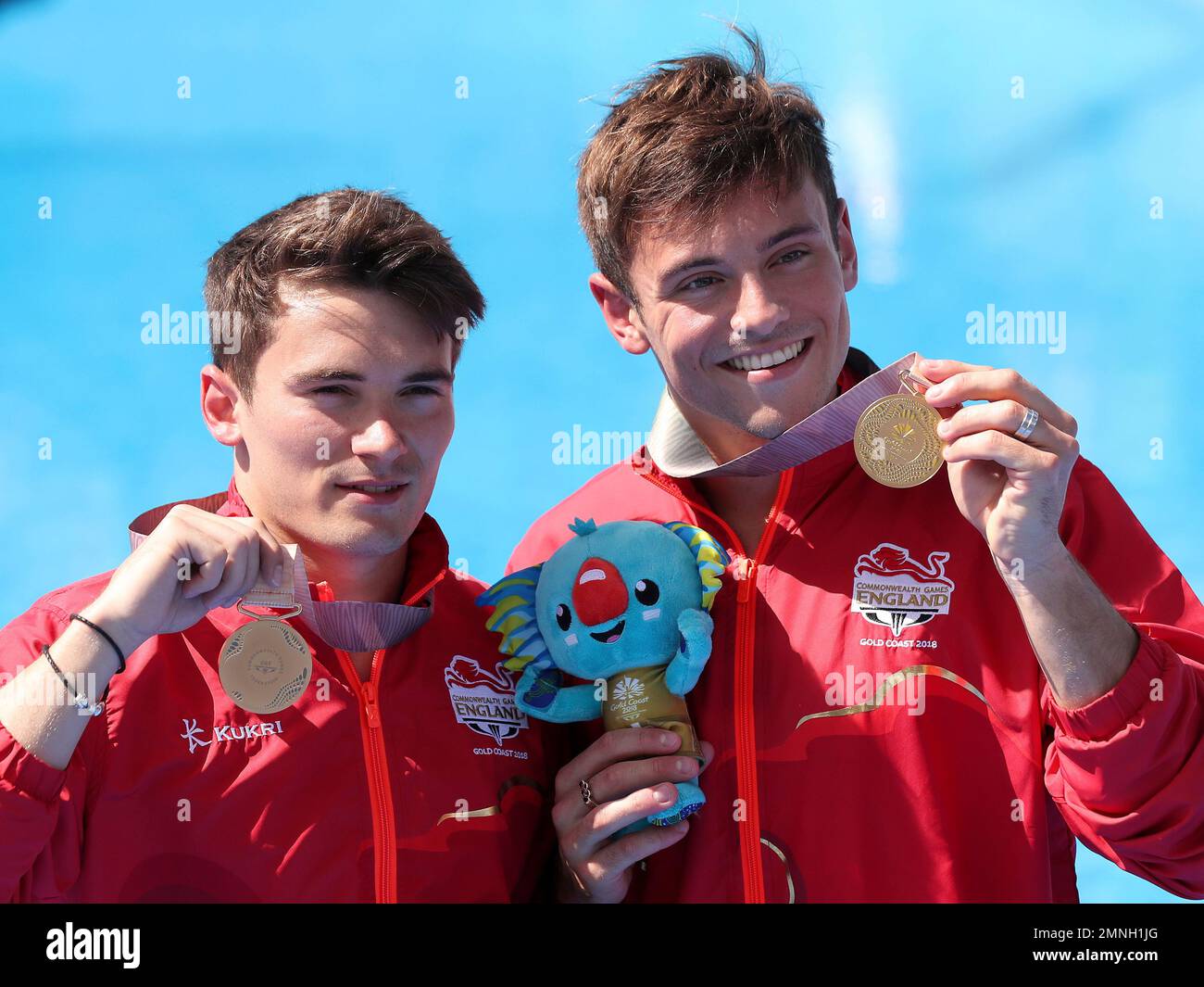 England's Thomas Daley, right, and Goodfellow hold up their gold medals ...