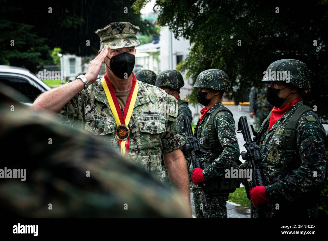 U.S. Navy Rear Adm. Derek Trinque, commander, Task Force 76/3, receives ...