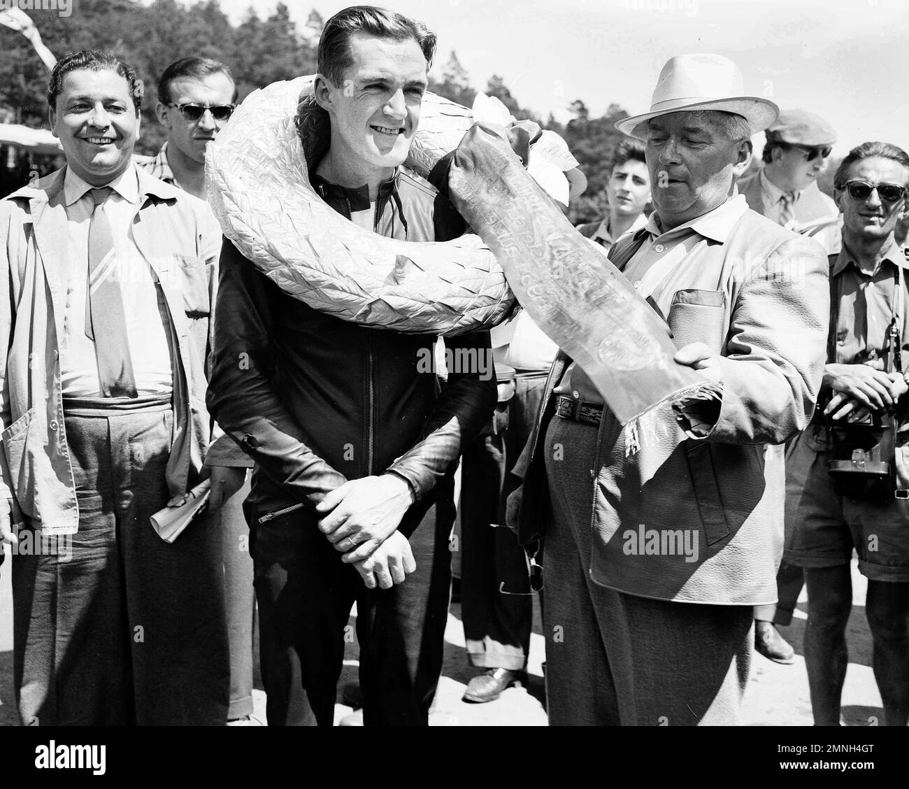 Ray Amm of Rhodesia is decorated with the winner's wreath after he ...