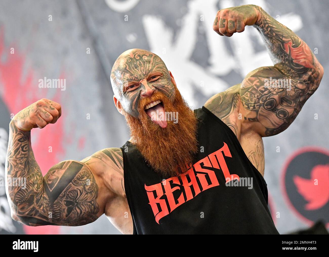 Bodybuilder Jens shows his muscles at the world's largest fitness trade ...