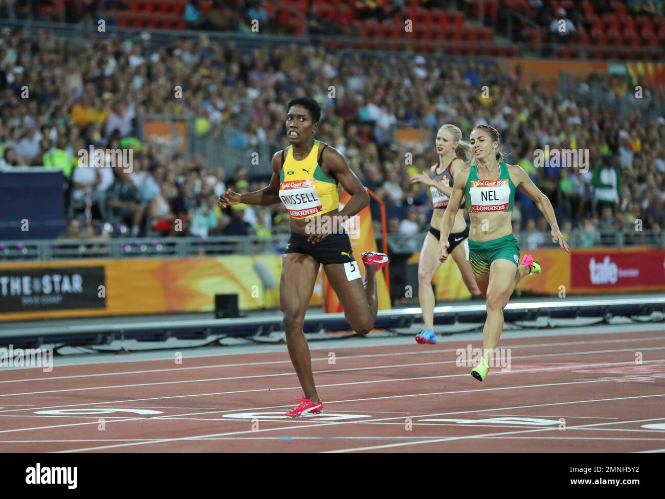Jamaica's Janieve Russell crosses the finish line to win the gold medal ...