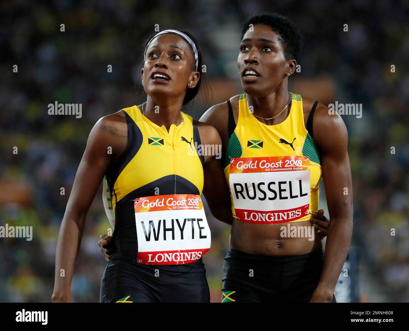 Jamaica's Janieve Russell,right celebrates after winning the women's ...