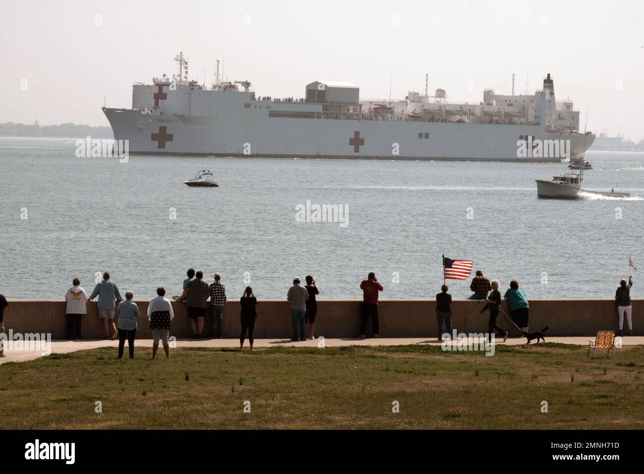 NORFOLK, Va. (March 28, 2020) – People gather to watch the Military ...