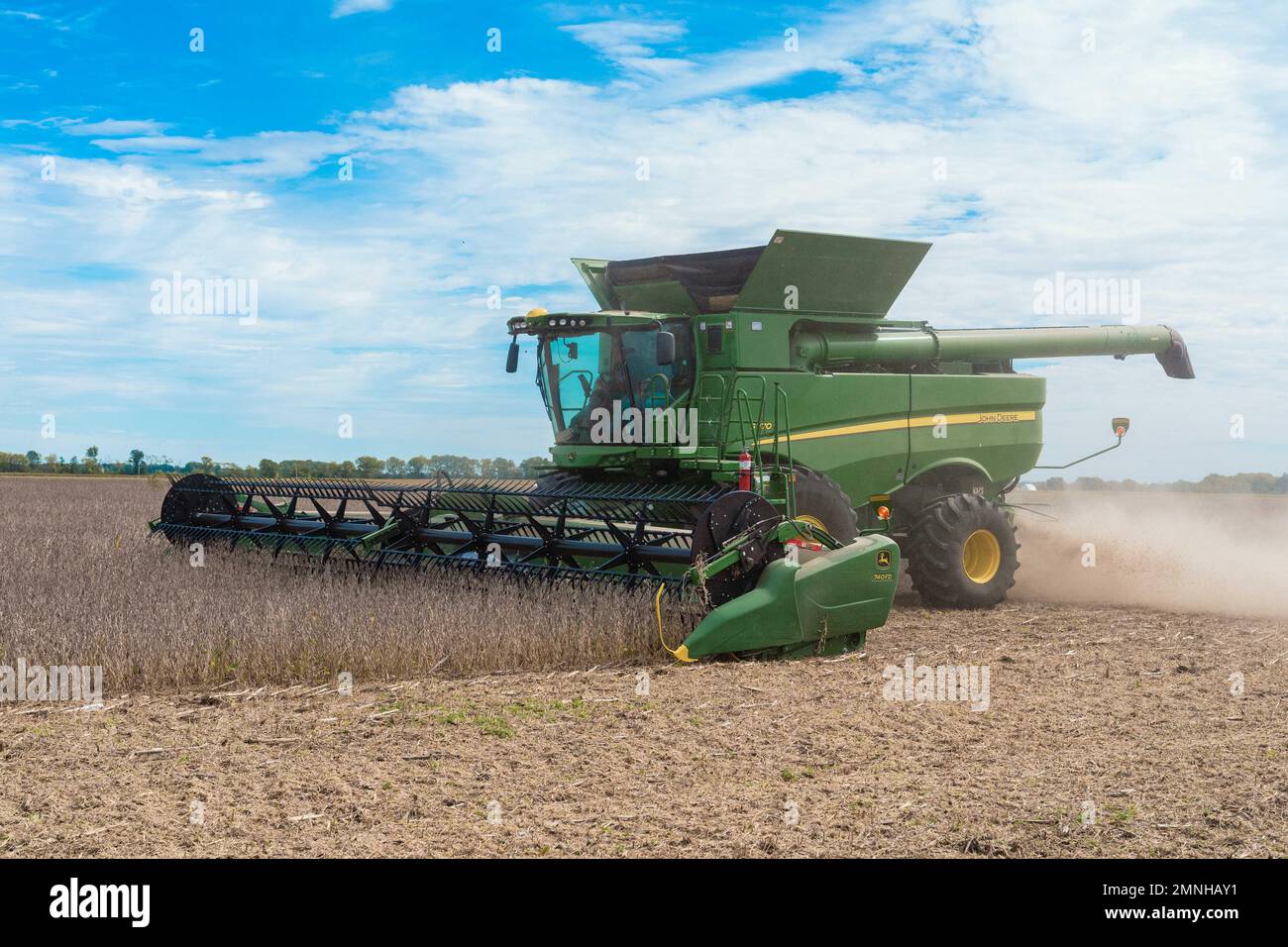 A farmer using a John Deere S770 Combine to harvest soybeans on his 135 ...