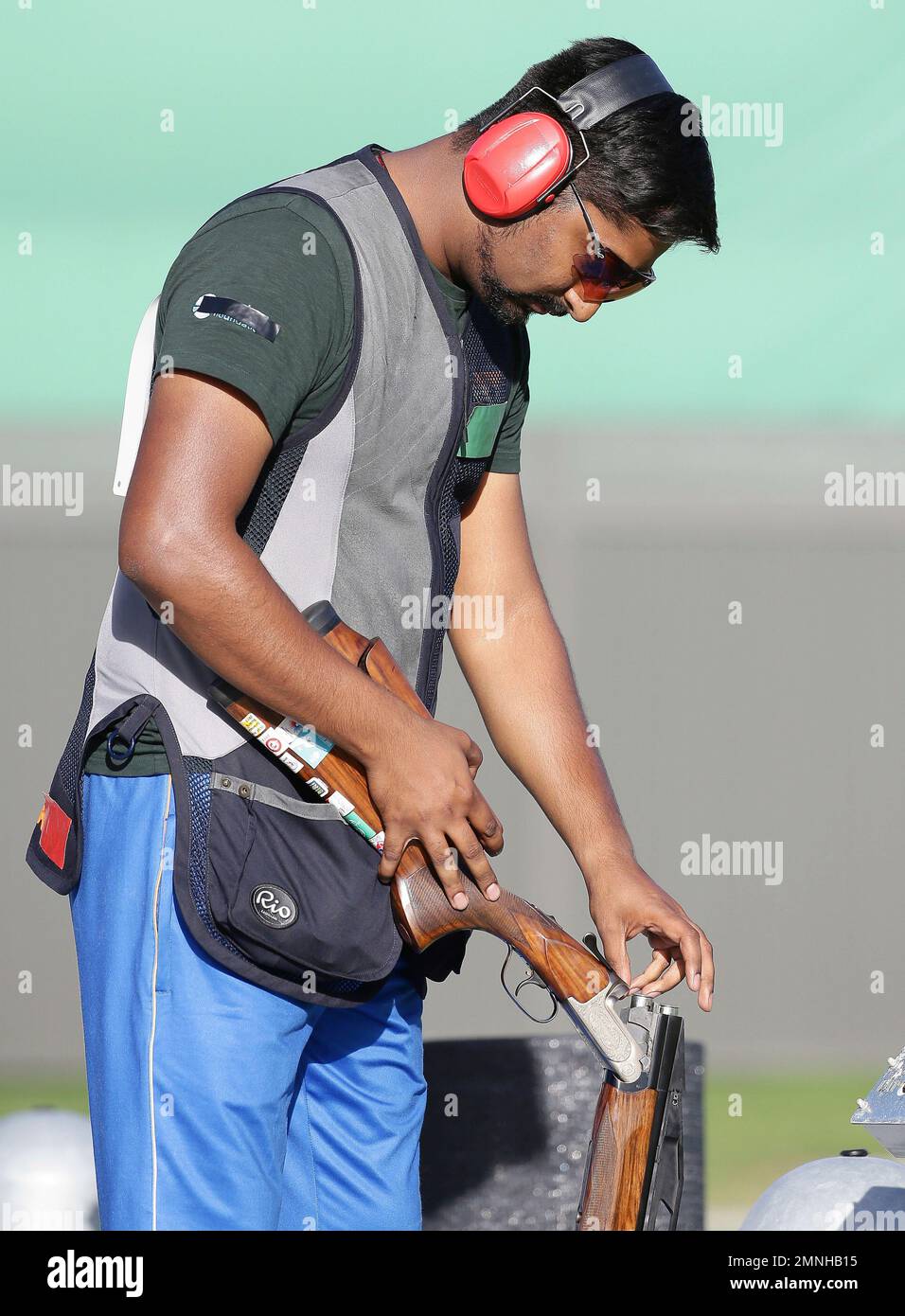 Ankur Mittal of India reacts after missing a target during the men's ...