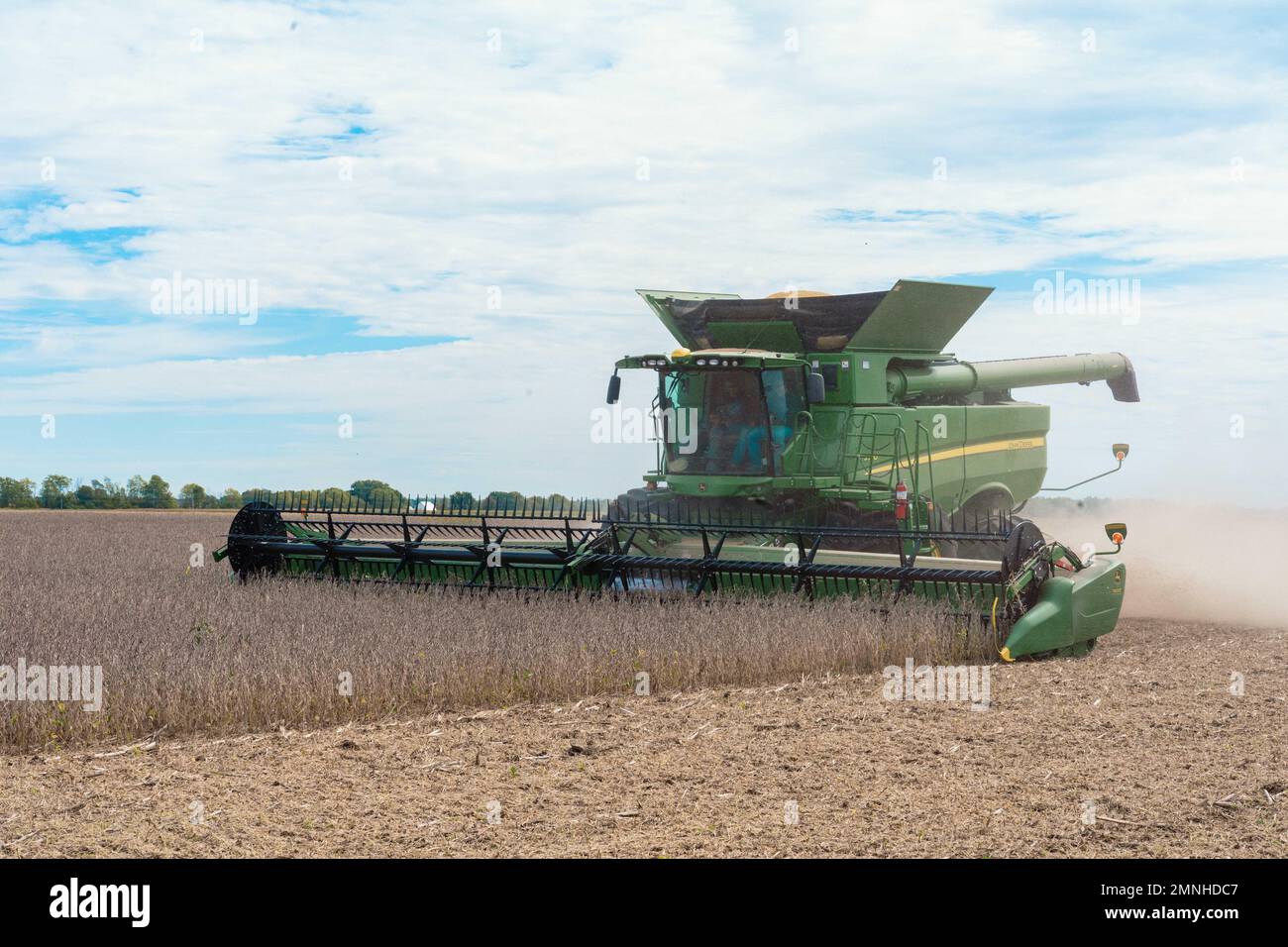 A farmer using a John Deere S770 Combine to harvest soybeans on his 135 ...