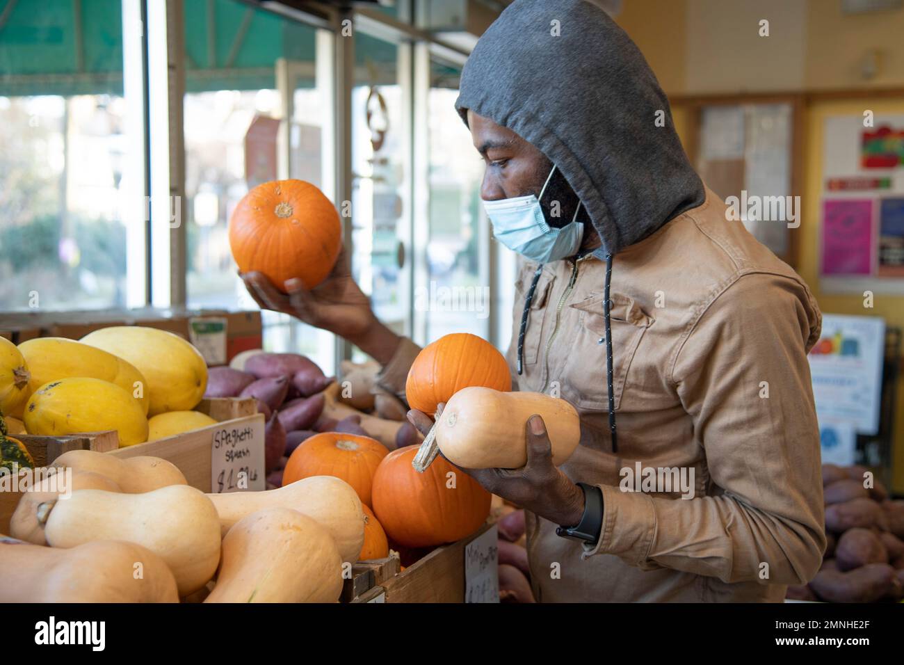 A customer inspects fresh vegetables at the Takoma Park Silver Spring ...