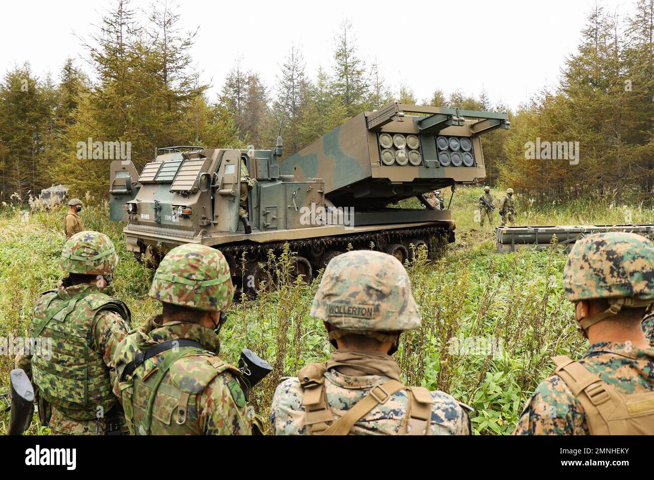 U.S. Marines with 12th Marine Regiment, 3d Marine Division, observe ...