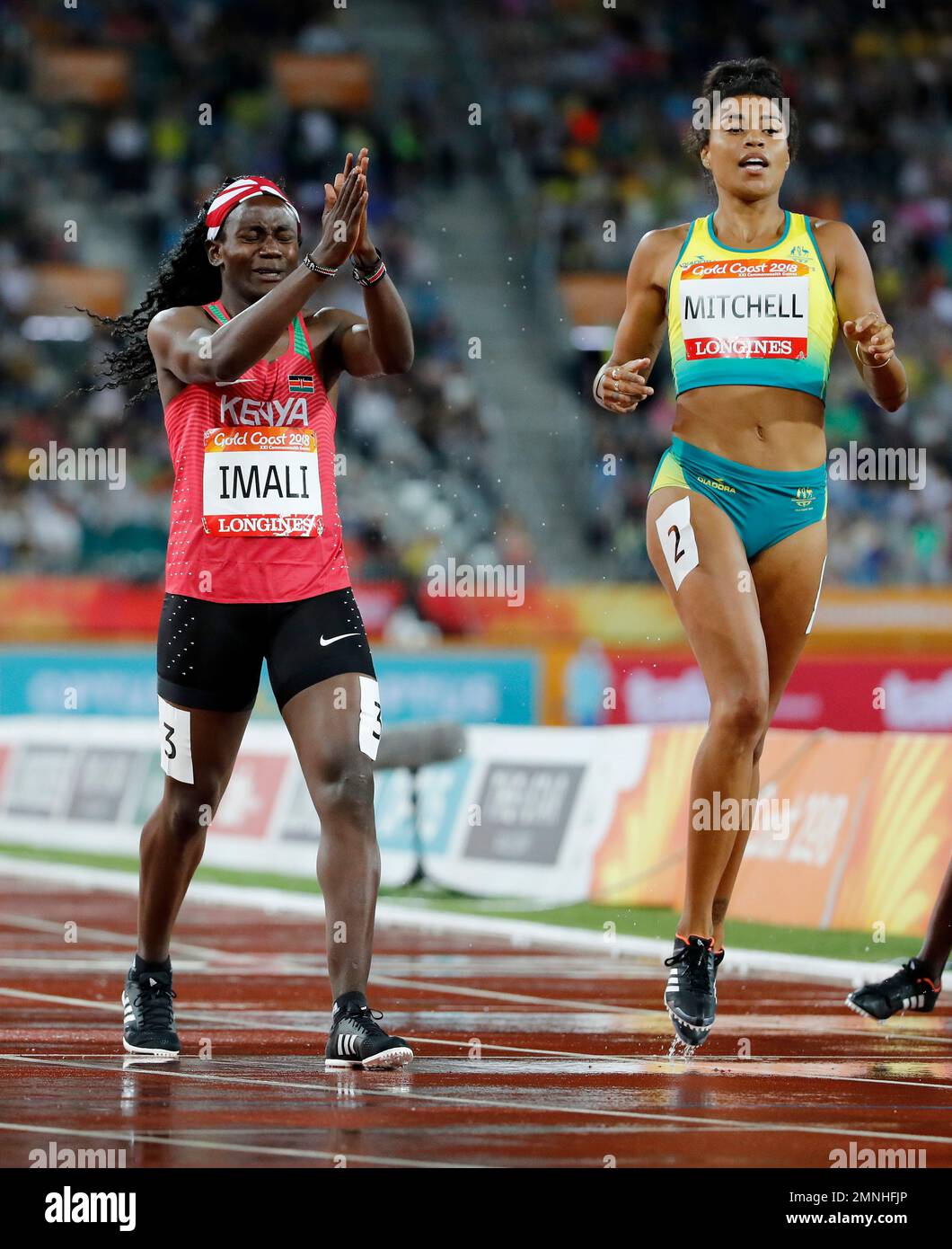 Kenya's Maximila Imali, left, reacts as she crosses the finish line to ...