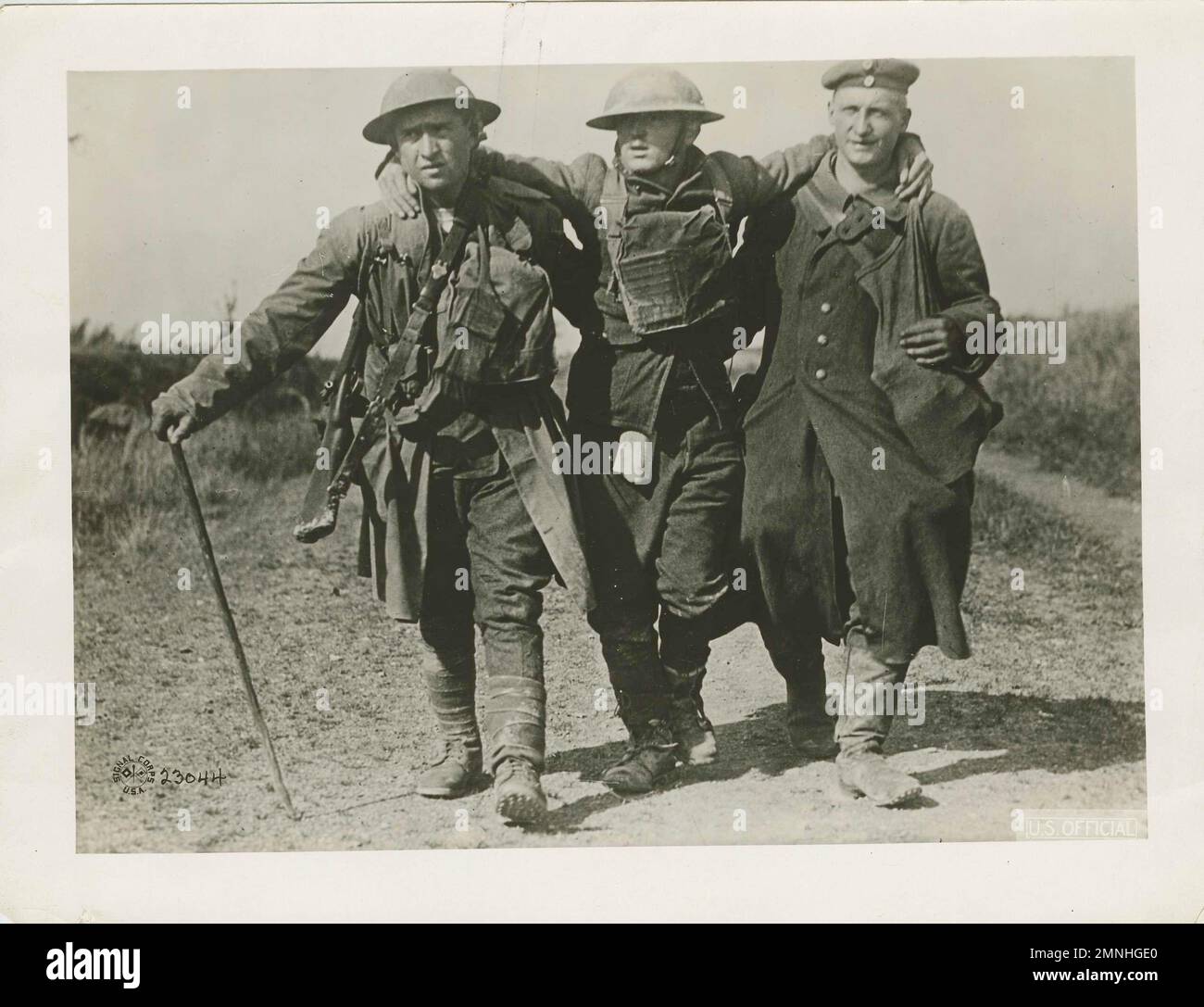 Soldiers assist a wounded comrade to a first aid station during World ...