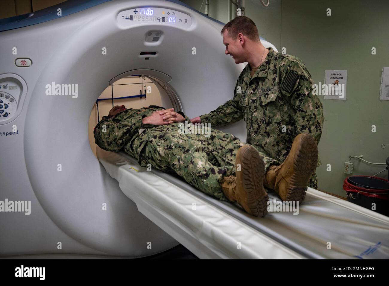 A hospital Corpsman 3rd Class demonstrates proper positioning of a ...