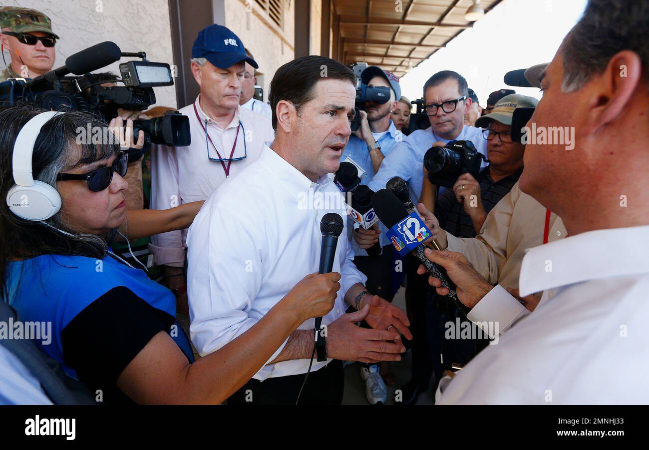 Arizona Gov. Doug Ducey, center, speaks with the media after meeting ...
