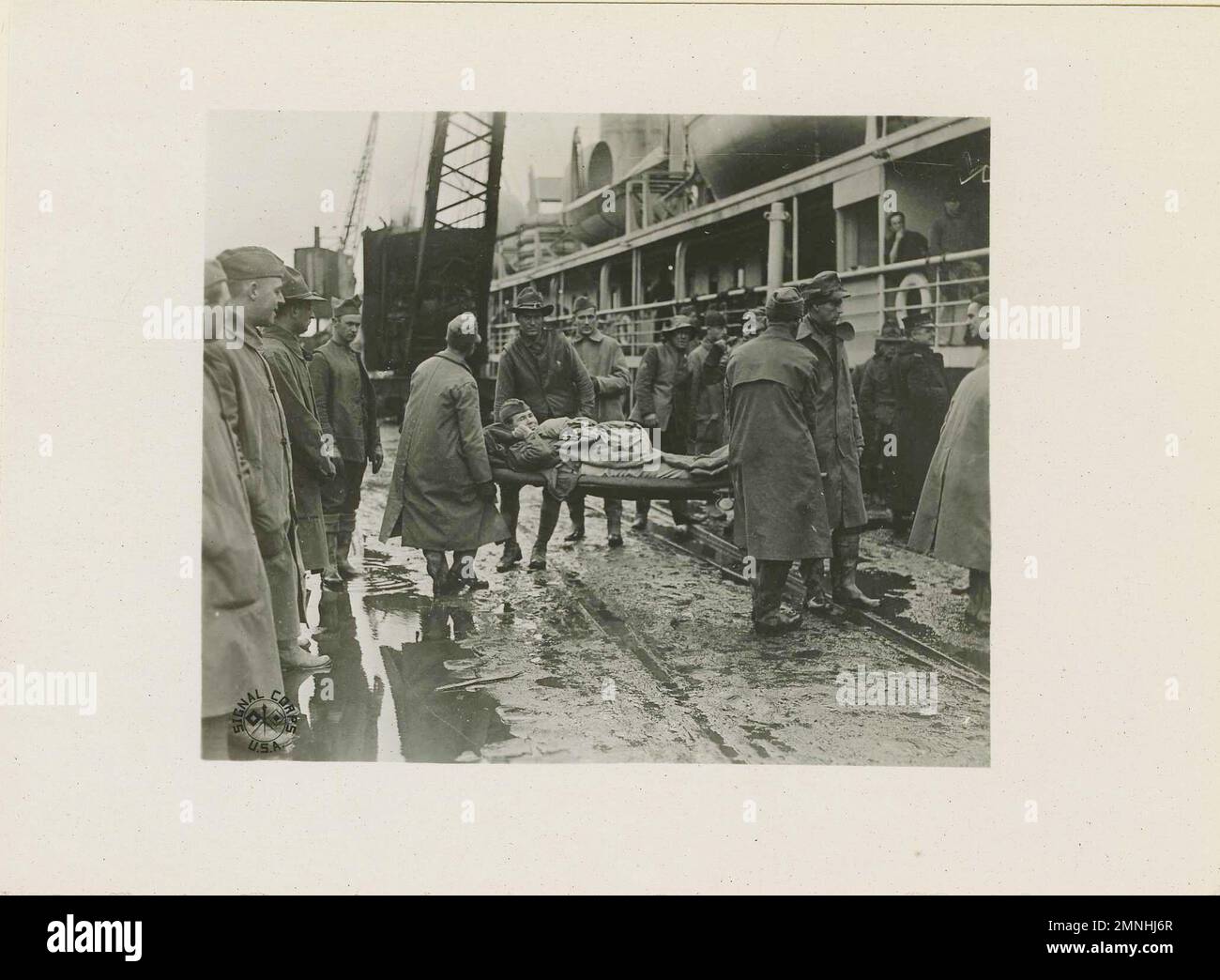 Carrying wounded soldiers from the ambulances to hospital ship Mercy ...