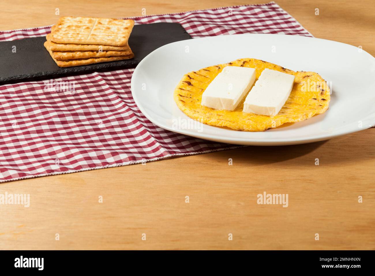 Tasty traditional breakfast in Colombia; Arepa of yellow corn with ...