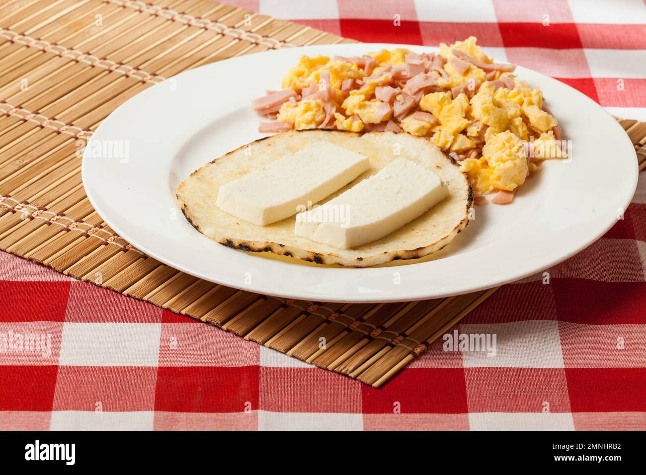 Arepa for breakfast, cheese and scrambled egg, a traditional Colombian ...