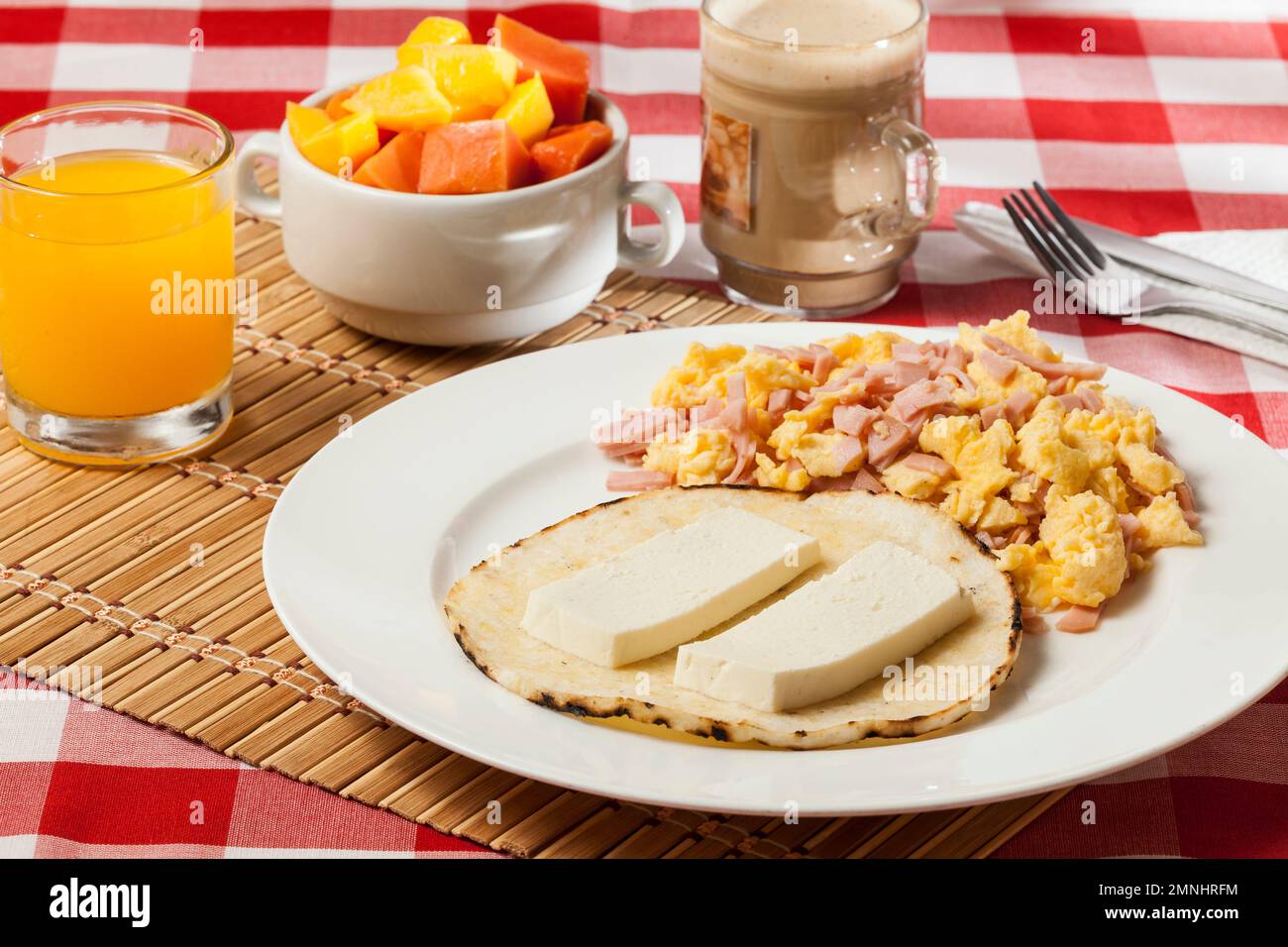 Arepa for breakfast, cheese and scrambled egg, a traditional Colombian ...