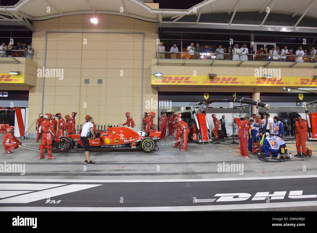 Ferrari mechanic Francesco, lies on the ground, right, after being bitted by Ferrari driver Kimi ...