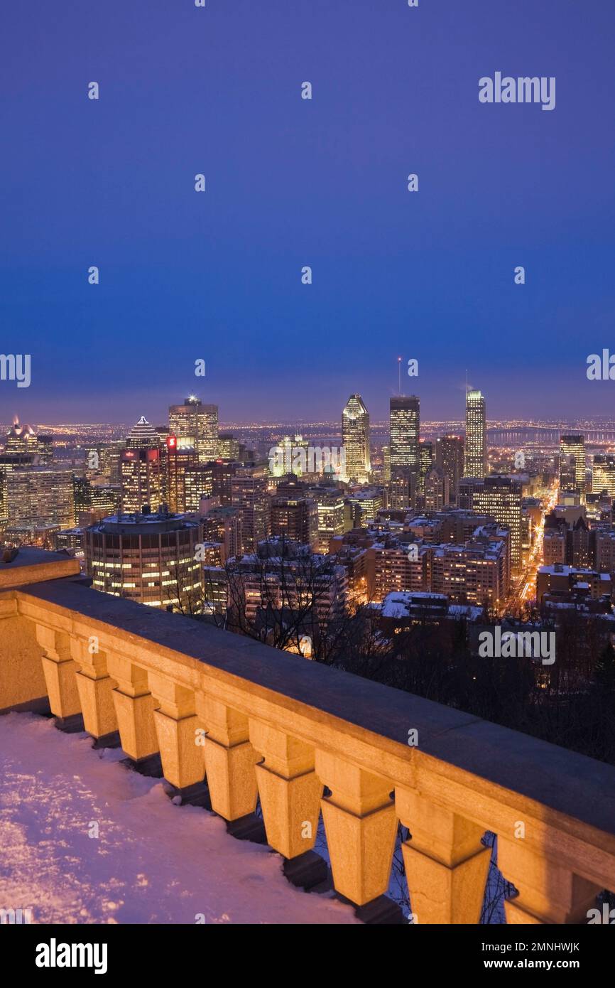 Cement railing and Montreal skyline illuminated at dusk in winter taken ...