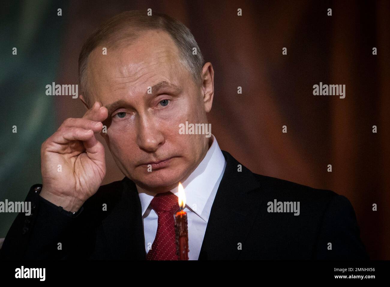 Russian President Vladimir Putin crosses himself as he attends the ...