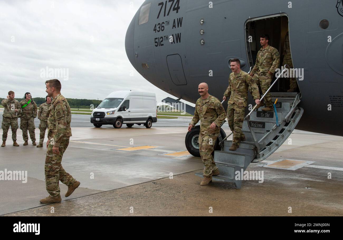 Deployed personnel deplane a C-17 Globemaster III at Dover Air Force ...