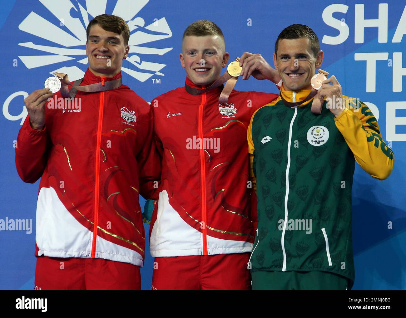 Men's 100m breaststroke gold medalist Adam Peaty, centre, stands with ...