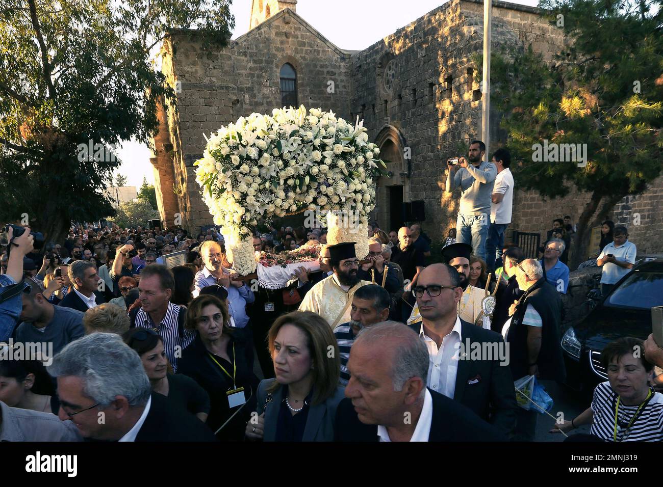 Greek Orthodox Christian worshipers hold aloft the bier depicting ...