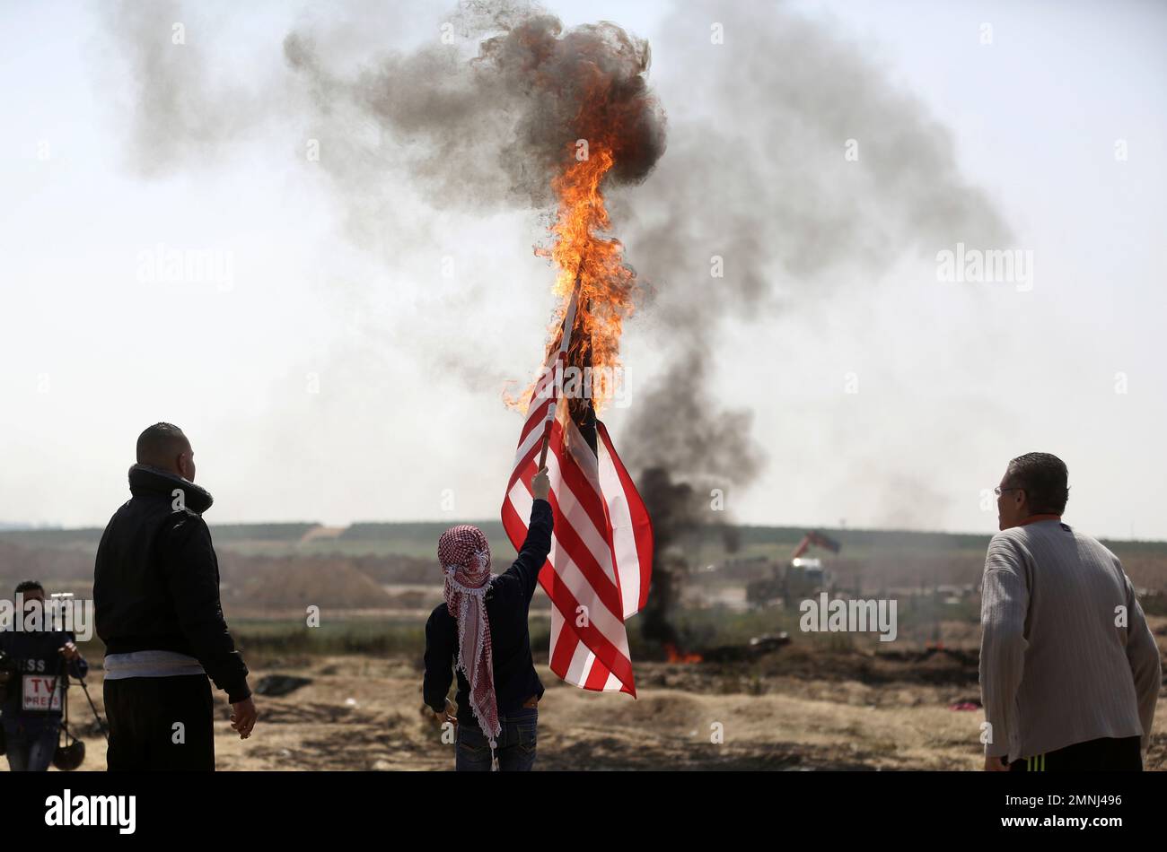 Palestinian protesters burn an American flag during a protest at the ...