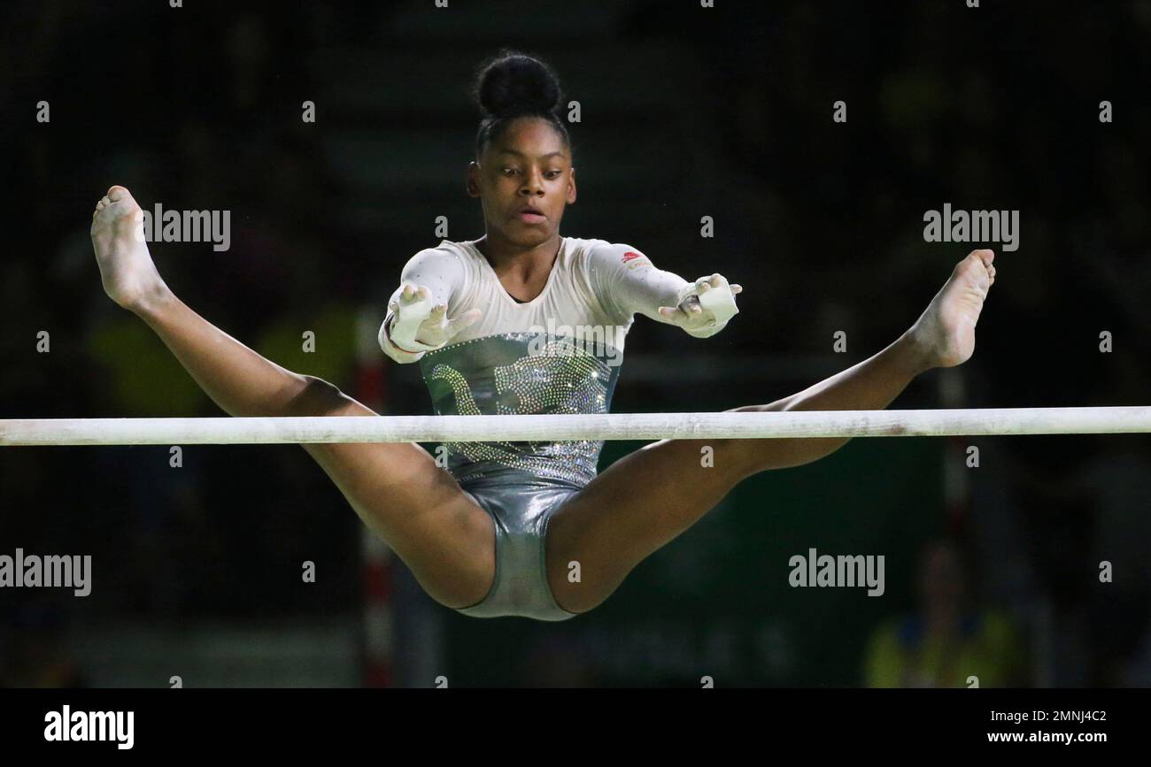 England's Taeja James competes in the uneven bars during the women's ...