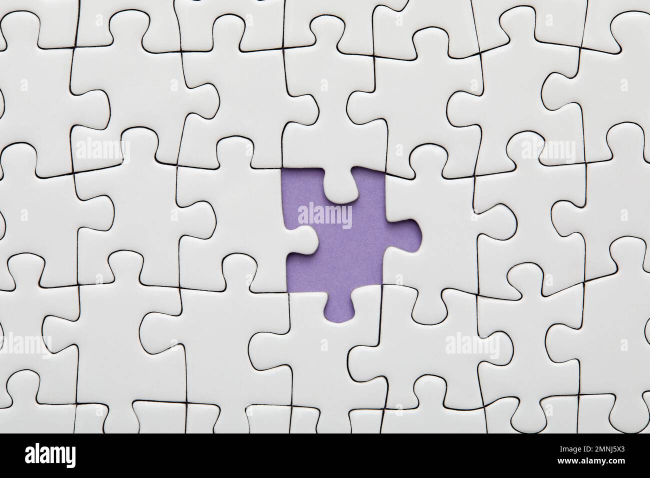 Piece missing from white jigsaw puzzle Stock Photo - Alamy