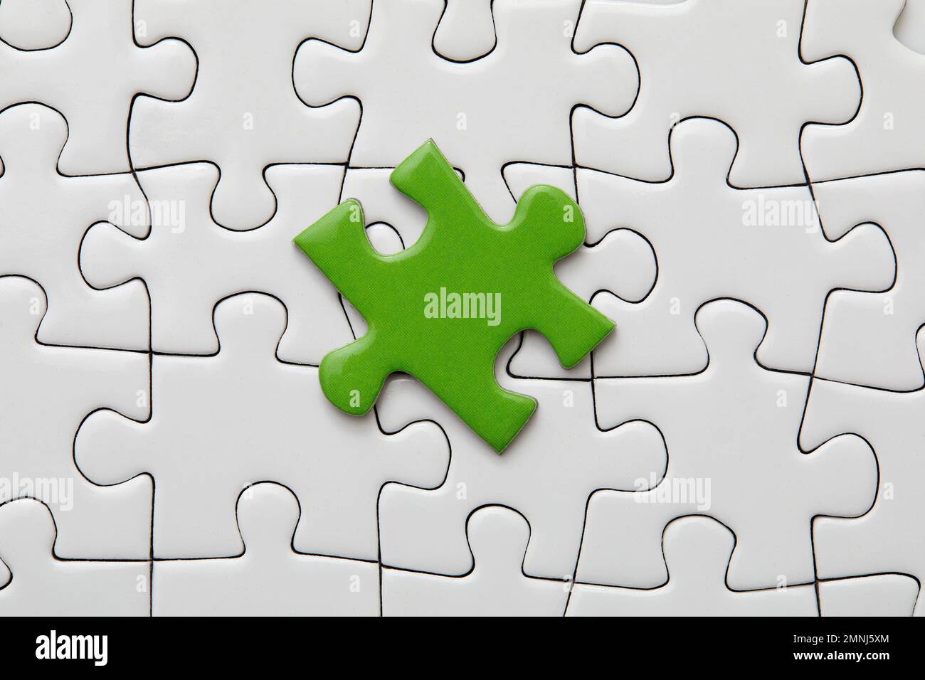 Green jigsaw piece Stock Photo - Alamy