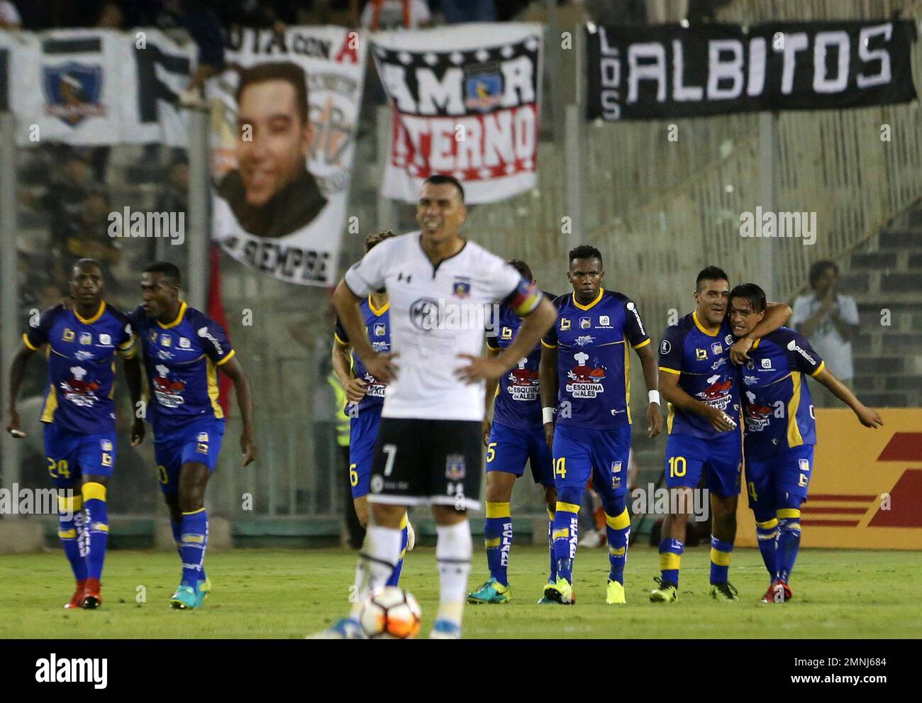 Players of Ecuador's Delfin, behind, celebrate their second goal ...