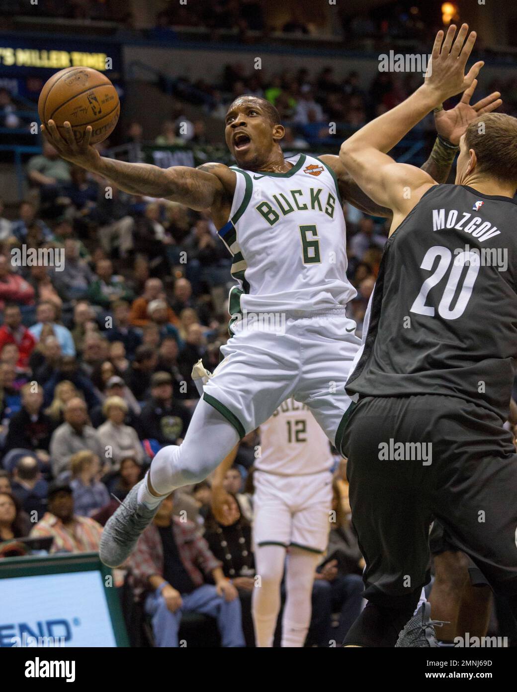 Milwaukee Bucks guard Eric Bledsoe, left, goes up for a basket against ...