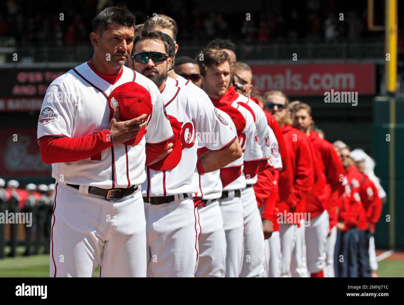 Washington Nationals manager Dave Martinez, left, stands with his team ...