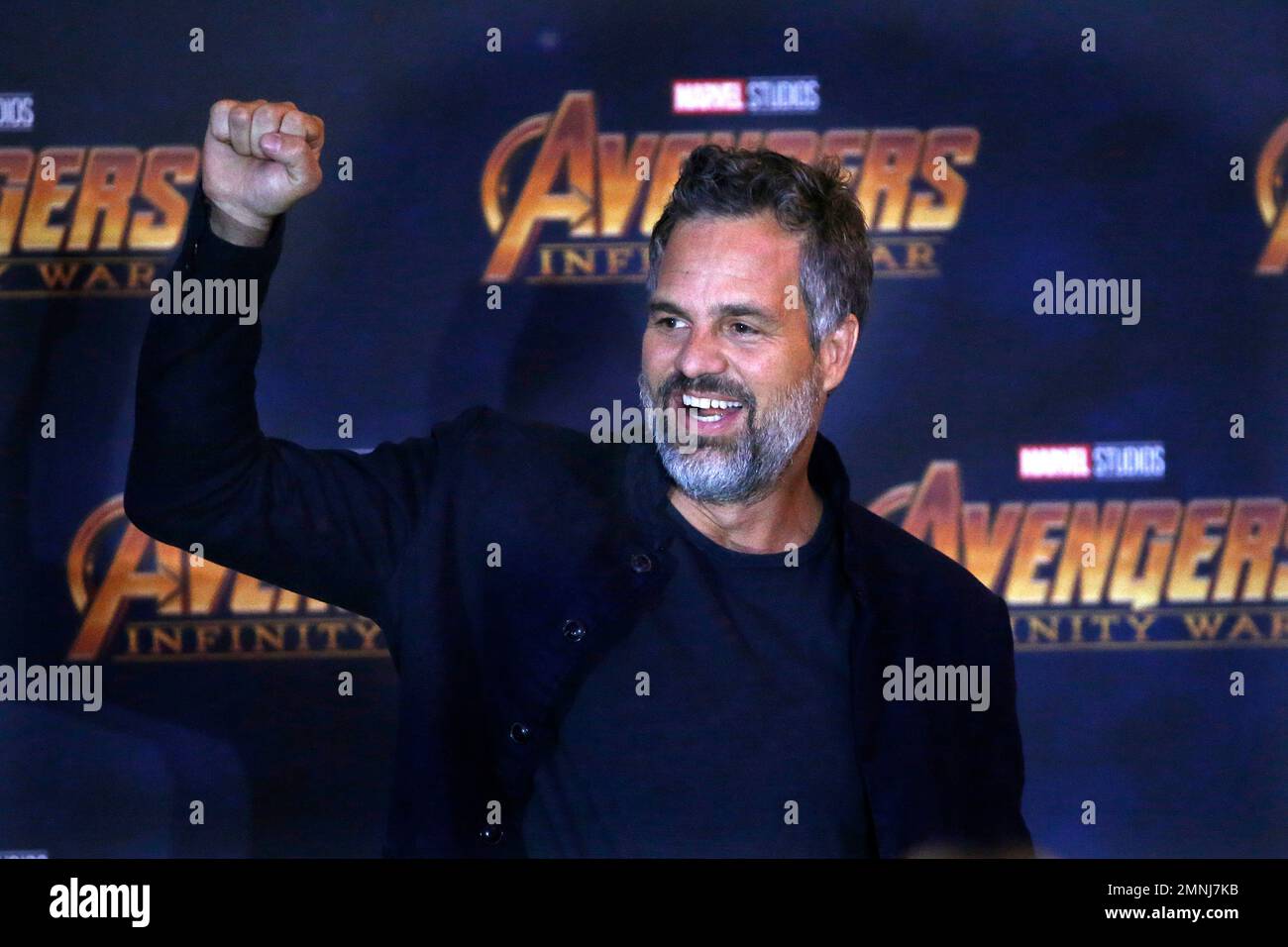 Actor Mark Ruffalo raises his right fist during a press conference to ...