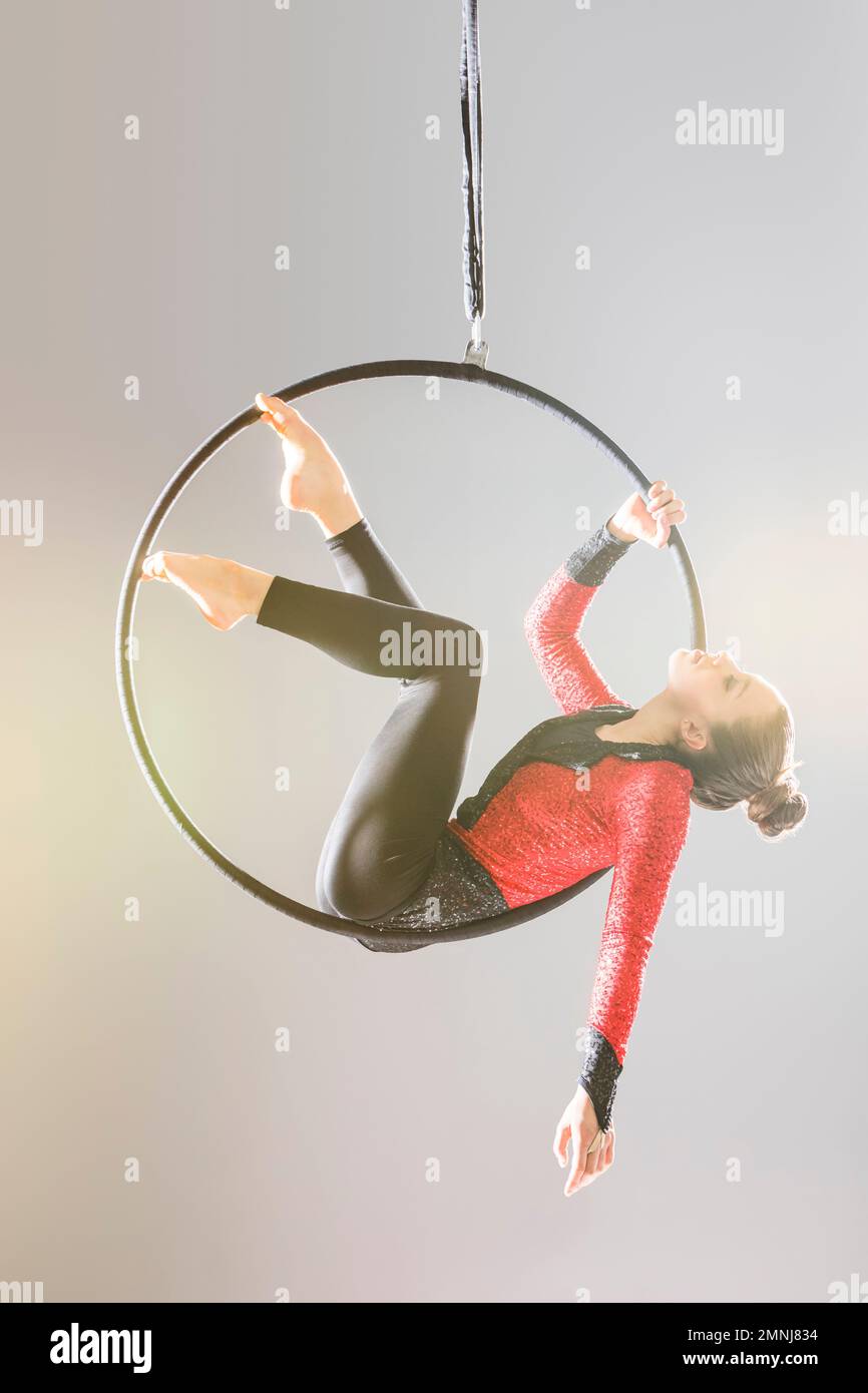 Young acrobat performing on aerial hoop Stock Photo - Alamy